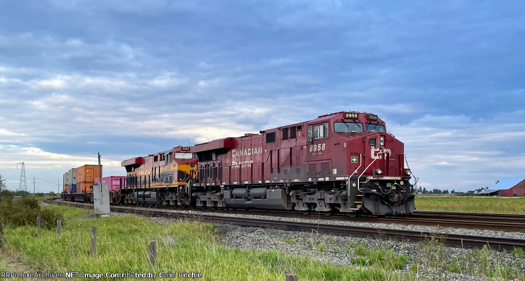 CP 8958/ KCS 4893 waiting to enter Robert's Bank from W/B Fisher with a loaded, unit stack train